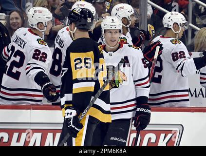 Chicago Blackhawks defenseman Connor Murphy, right, moves the puck ...