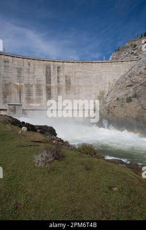 199 foot tall Gibson Dam towers over the spring runoff of the Sun River ...