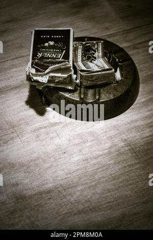 Ash tray with cigarettes on wooden background Stock Photo - Alamy