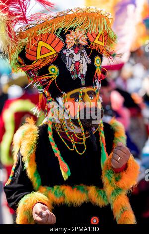 A person with a colorful chinelo costume, dancing in a carnival in ...