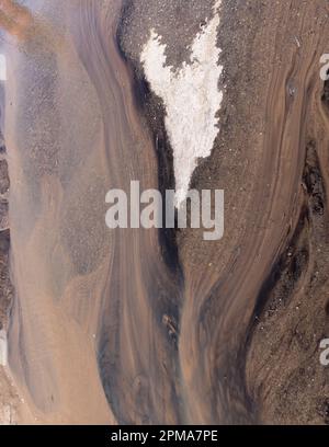 Spring melting creates interesting mud flows as gravity pulls the water ...