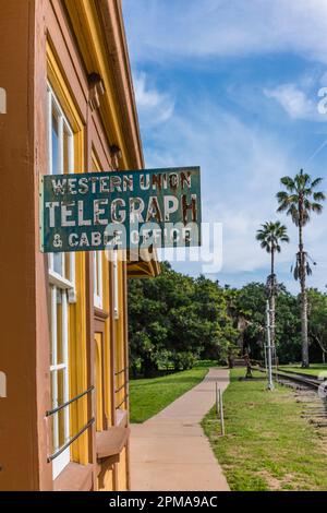 Western Union sign at Goleta, CA train station building with two palm ...