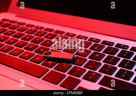 Modern laptop with metallic USB flash drive isolated on white ...