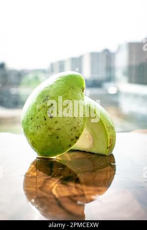 Green mango or baby mango is a small round mango with a vibrant emerald ...