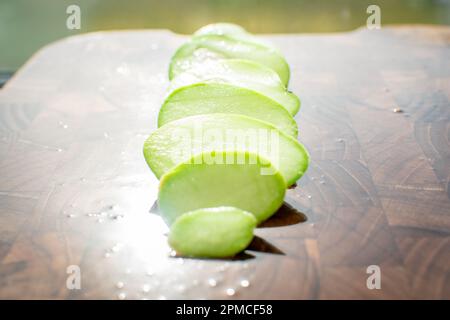 Green mango or baby mango is a small round mango with a vibrant emerald ...