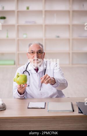 Old doctor in planning retirement concept Stock Photo - Alamy