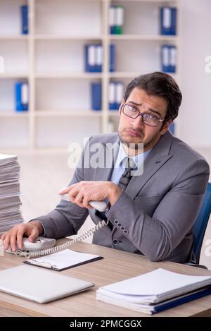 Young businessman employee unhappy with excessive work Stock Photo - Alamy