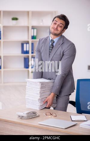 Young businessman employee unhappy with excessive work Stock Photo - Alamy