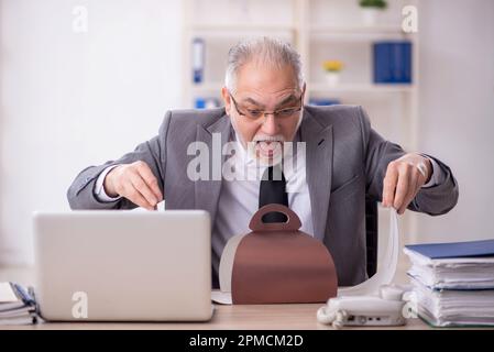 Old businessman employee eating cake at workplace Stock Photo - Alamy