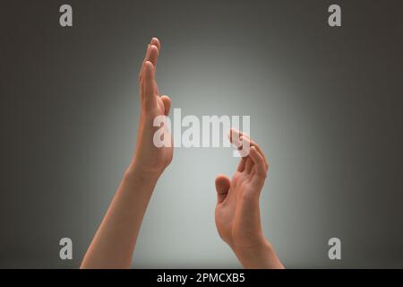 Women's palms up in a dance gesture on the gray background Stock Photo ...