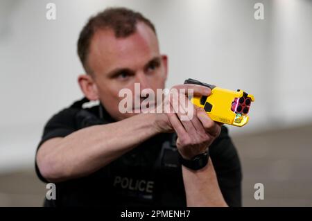 An officer holds the new Taser 7 during a demonstration as Hampshire ...