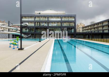 Types of pools at a swimming pool area. Two happy senior adults playing ...