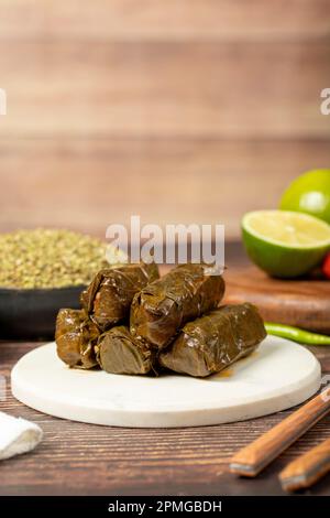 Olive oil leaf wrap. Aegean cuisine delicacies. Grape leaf wrap with ...