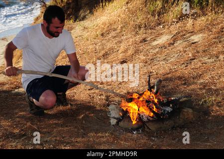 Campers burning fire in Turkey Stock Photo - Alamy