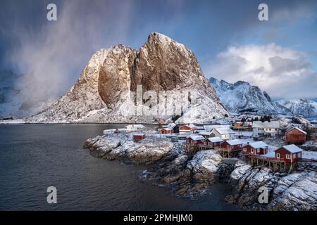 Red Norwegian Rorbuer Huts and Festhaeltinden mountain in winter ...