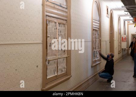 Visitors read the old newspapers taped to the windows by Melbourne ...