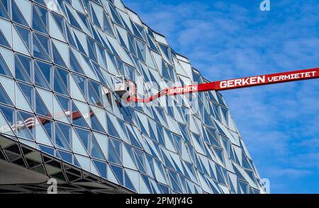 Building cleaners clean window panes, clean a facade, truck working ...