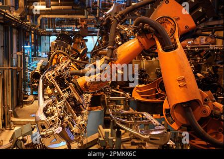 Robotic welder machine tools process metal details in shop Stock Photo ...
