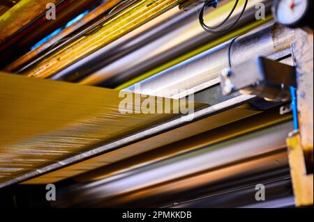 Thin strained wires pulled through distributor comb calender Stock ...