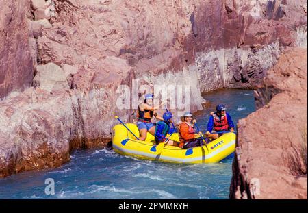 Argentina, Mendoza region. Tourists rafting in dinghy in fast flowing ...