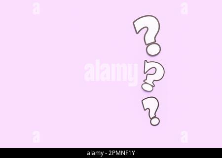 Paper with question marks on lilac background Stock Photo - Alamy