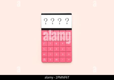 Calculator with question marks on beige background Stock Photo - Alamy