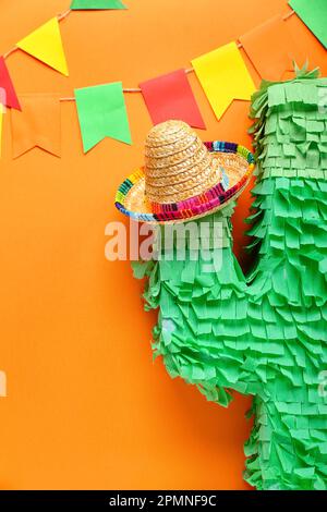 Mexican pinata with sombrero hat and flags on color background Stock ...
