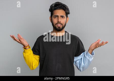 What Why. Sincere irritated indian man raising hands in indignant ...