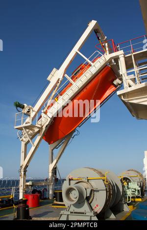 Aft of orange free fall lifeboat with door secured on launching ramp ...