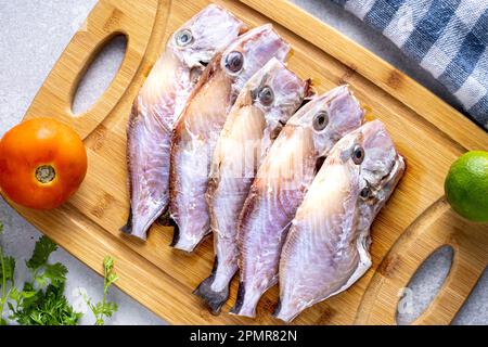 Fried "peroa" fish, lettuce salad, tomato, lemon, rice, beans and ...