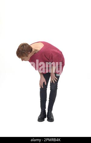 crouched woman looking at the ground to the side looking for something ...