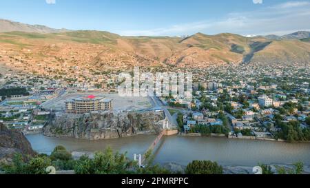 A horizontal photo of Fayzabad cityscape with a view of Kokcha river ...
