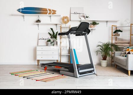Modern treadmill in interior of living room Stock Photo - Alamy