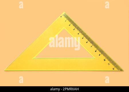 Yellow triangle plastic ruler on white background Stock Photo - Alamy
