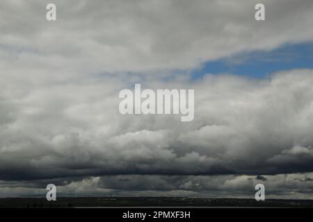 Heavy gray storm clouds hanging over the earth Stock Photo - Alamy