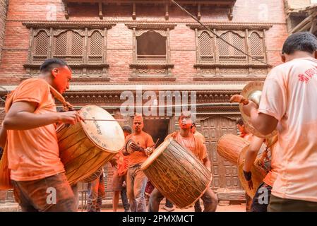Devotees play the traditional instruments during a chariot procession ...