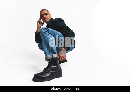 African American male model crouching like a gangster isolated on white ...