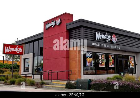 Wendy's Hamburgers fast food restaurant sign against blue sky copy space in Ontario Canada North ...