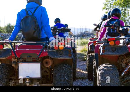 Friends driving off-road with quad bike or ATV and UTV vehicles Stock ...