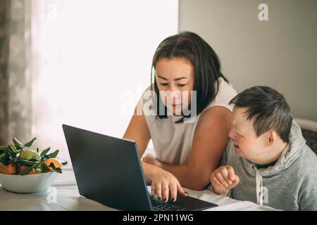 Down syndrome woman at home using smartphone with a happy face standing ...