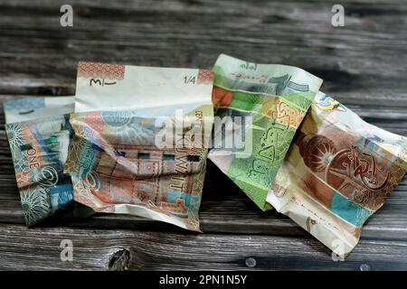 crumpled Kuwaiti money of quarter, half and one KWD Kuwait dinar bills ...