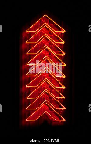 Set of red arrows neon light pointing down Stock Photo - Alamy
