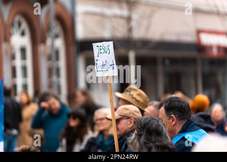 Religious protest sign above a crowd of protesers, during Easter peace ...