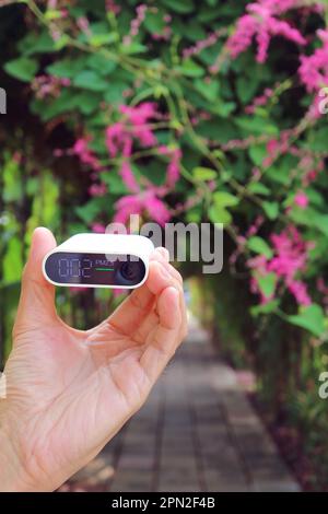 Hand holding air quality detector Stock Photo - Alamy