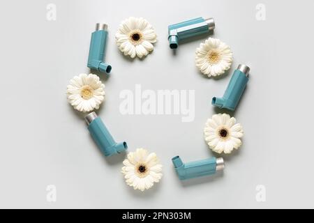 Frame made of inhaler with flowers on grey background Stock Photo - Alamy