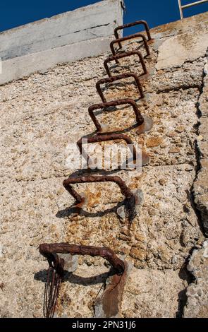 Rusty metal ladder on the stone pier Stock Photo - Alamy