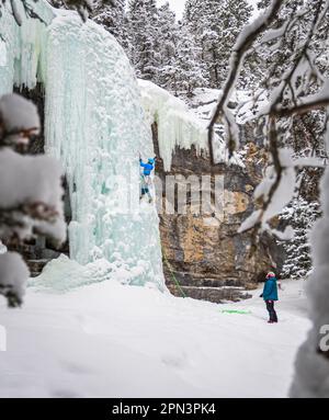 Rowan Lovell and Brandon Prince climbing in Johnston Canyon Stock Photo ...
