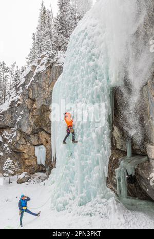 Rowan Lovell and Brandon Prince climbing in Johnston Canyon Stock Photo ...