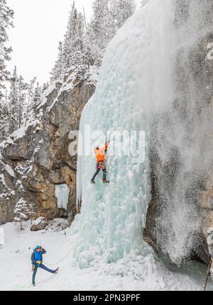 Rowan Lovell and Brandon Prince climbing in Johnston Canyon Stock Photo ...