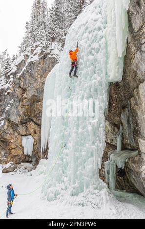 Rowan Lovell and Brandon Prince climbing in Johnston Canyon Stock Photo ...